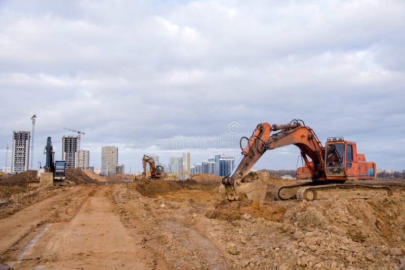 Group of the Excavators for Dig Ground Trenching at a Construction Site ...
