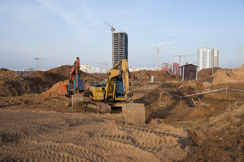 Group of the Excavators for Dig Ground Trenching at a Construction Site ...