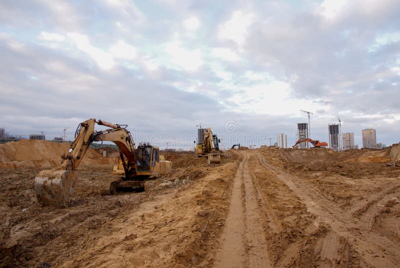 Group of the Excavators for Dig Ground Trenching at a Construction Site ...