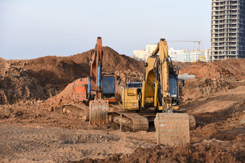 Group of the Excavators for Dig Ground Trenching at a Construction Site ...