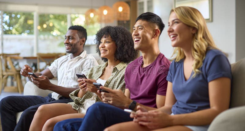 Group of Excited Multi-Racial Friends Sitting on Sofa Playing Computer ...