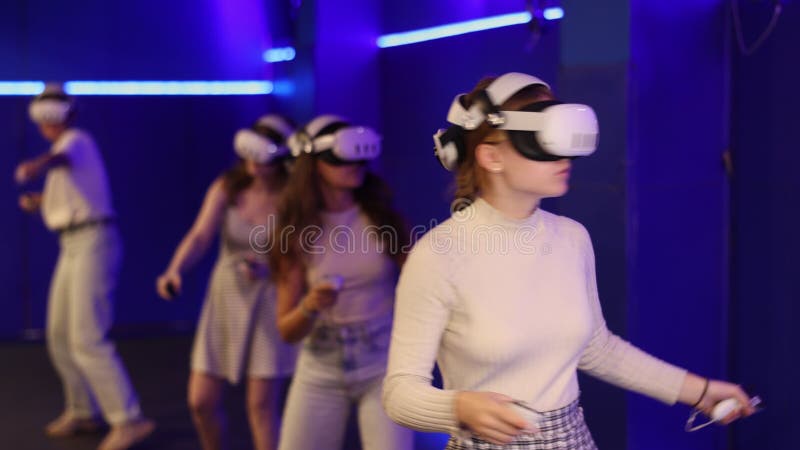Four Cheerful Emotional Young Female Friends in VR Goggles Standing in ...