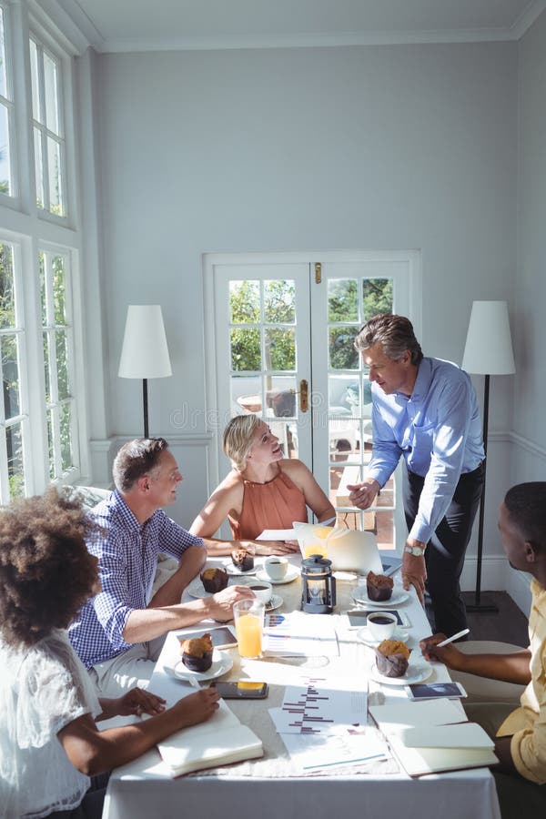 Group of Executive Using Laptop while Having Breakfast Stock Photo ...