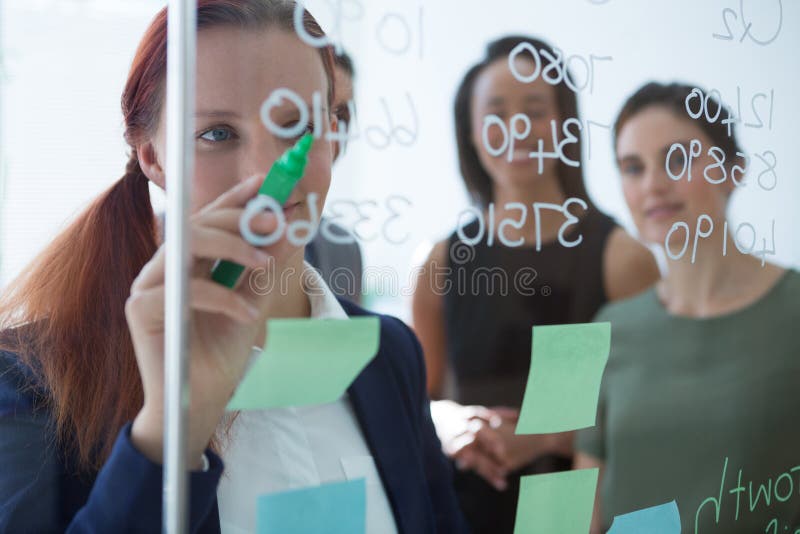 Group of Executives Discussing Over Information on the Wall Stock Photo ...