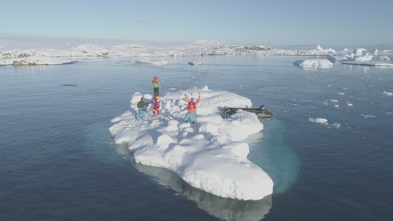 Group of Explorers Standing on an Ice Floe in Antarctica Under a Clear ...