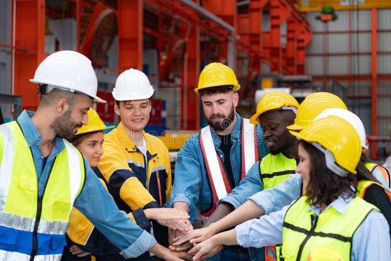 Group of Factory Workers in Hardhats with Joint Hands Together Stock ...