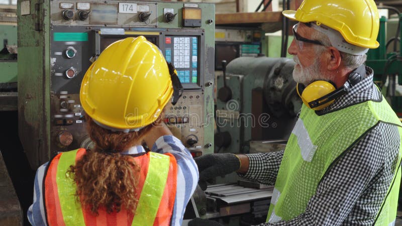 Group of Factory Workers Using Machine Equipment in Factory Workshop ...