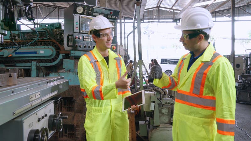 Group of Factory Workers Using Machine Equipment in Factory Workshop ...