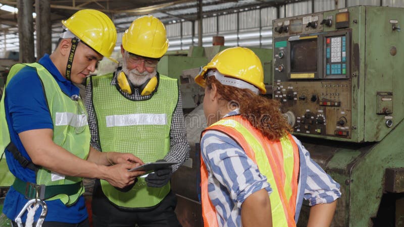 Group of Factory Workers Using Machine Equipment in Factory Workshop ...