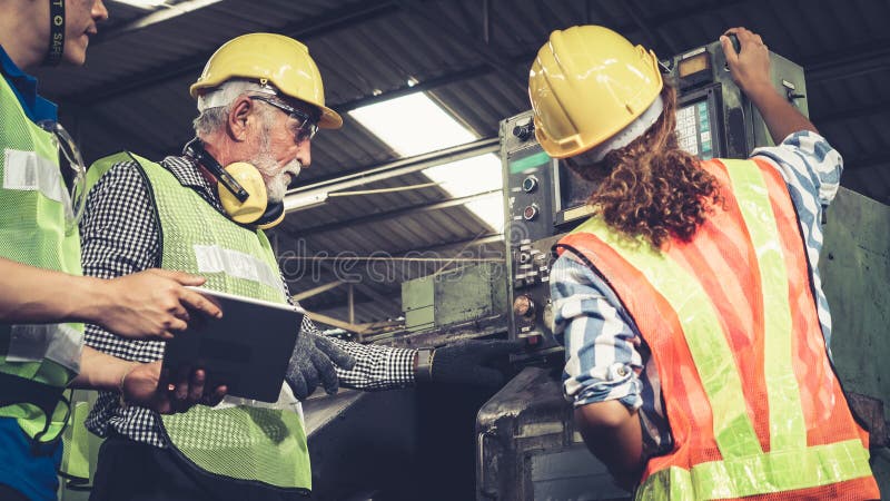 Group of Factory Workers Using Machine Equipment in Factory Workshop ...