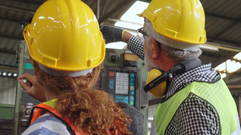 Group of Factory Workers Using Machine Equipment in Factory Workshop ...