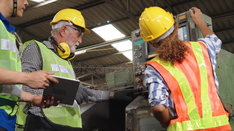 Group of Factory Workers Using Machine Equipment in Factory Workshop ...