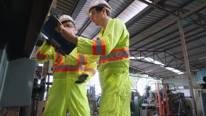 Group of Factory Workers Using Machine Equipment in Factory Workshop ...