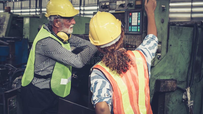 Group of Factory Workers Using Machine Equipment in Factory Workshop ...