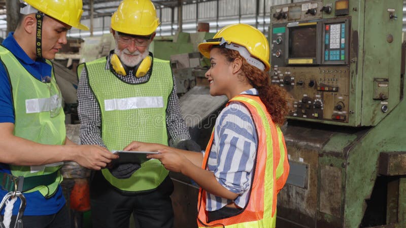 Group of Factory Workers Using Machine Equipment in Factory Workshop ...