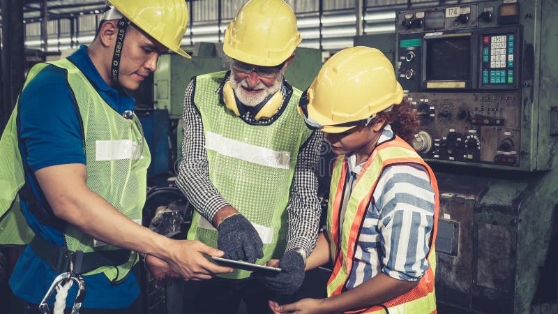 Group of Factory Workers Using Machine Equipment in Factory Workshop ...