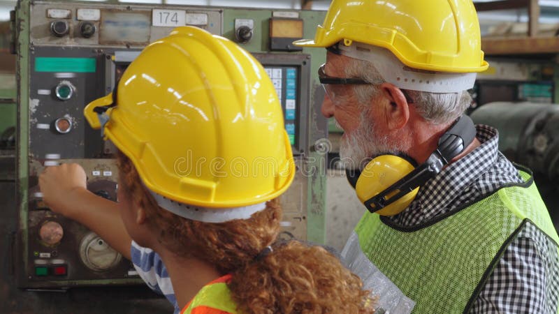 Group of Factory Workers Using Machine Equipment in Factory Workshop ...