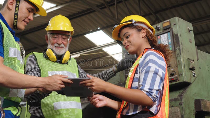 Group of Factory Workers Using Machine Equipment in Factory Workshop ...