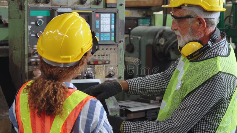 Group of Factory Workers Using Machine Equipment in Factory Workshop ...