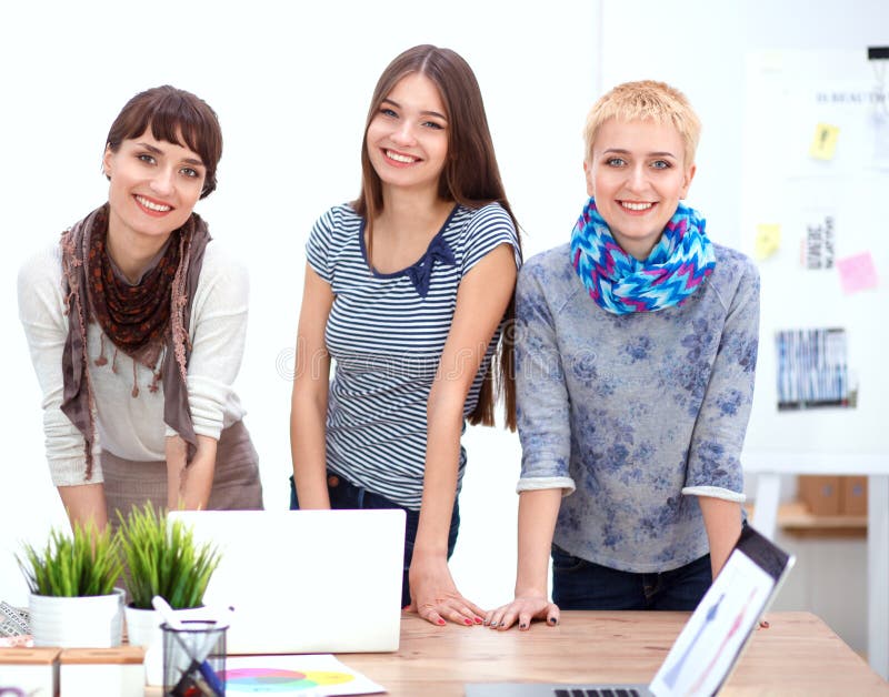 Group of Fashion Designers Discussing Designs in a Stock Image - Image ...