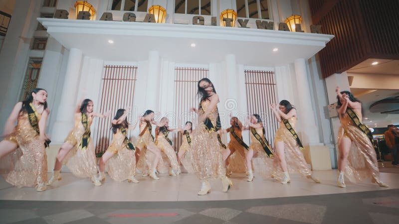 Group of Female Dancers in Golden Costumes Performing in a Mall ...