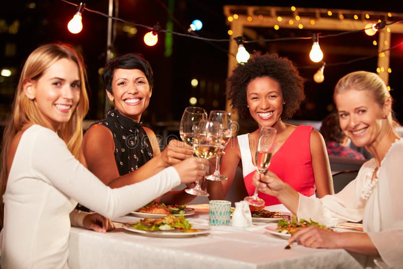 Group of Female Friends Eating Dinner at Rooftop Restaurant Stock Image ...