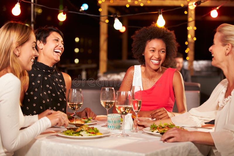 Group of Female Friends Eating Dinner at Rooftop Restaurant Stock Image ...