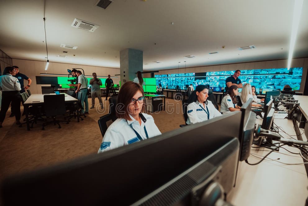 Group of Female Security Operators Working in a Data System Control Room Technical Operators ...