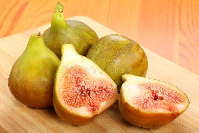 Group of Figs with Sliced Fig on a Wooden Cutting Board Stock Photo ...