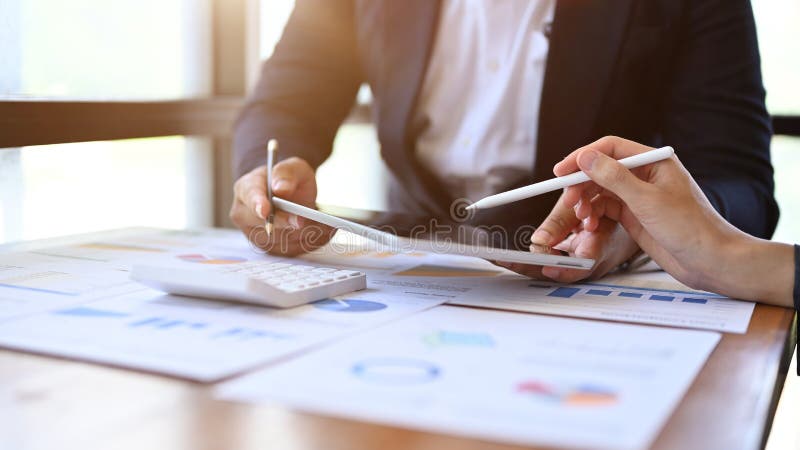 A Group of Financial Consultants or Accountants Working, Analyzing ...