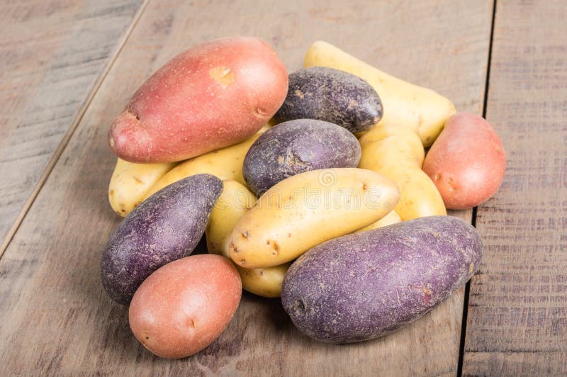 Group of Fingerling Potatoes on Wooden Table Stock Photo - Image of ...