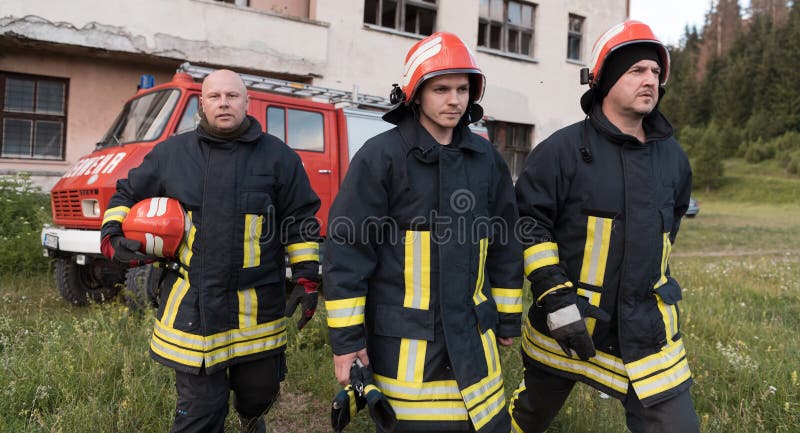 Group of Fire Fighters Standing Confident after a Well Done Rescue ...