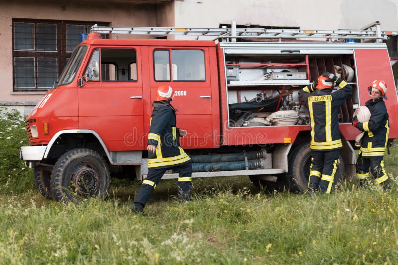 Group of Fire Fighters Standing Confident after a Well Done Rescue ...