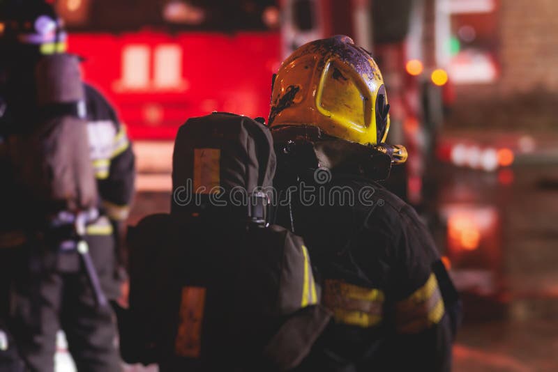 Group of Fire Men in Protective Uniform during Fire Fighting Operation ...