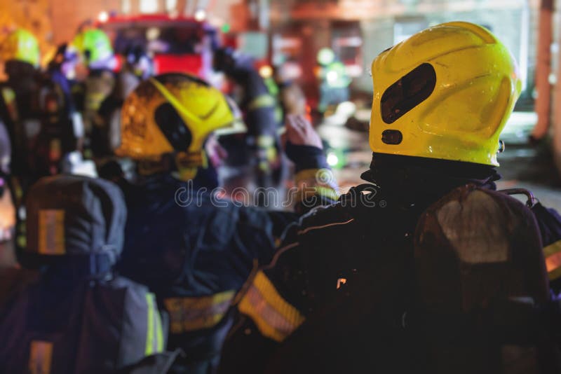 Group of Fire Men in Protective Uniform during Fire Fighting Operation ...