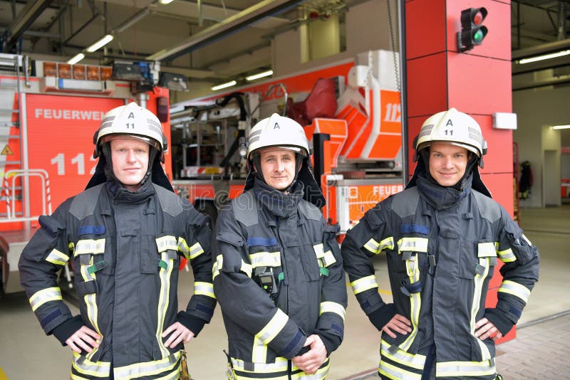 Group of Firefighters at the Emergency Vehicle in the Fire Station ...