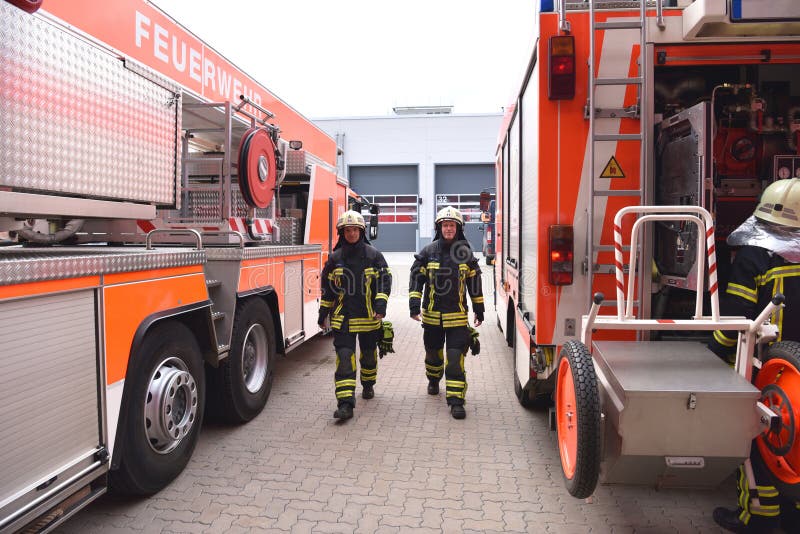 Group of Firefighters at the Emergency Vehicle in the Fire Station ...