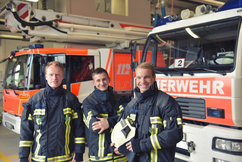 Group of Firefighters at the Emergency Vehicle in the Fire Station ...