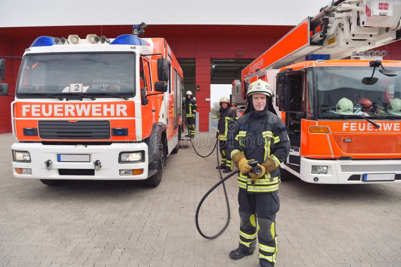Group of Firefighters at the Emergency Vehicle in the Fire Station ...