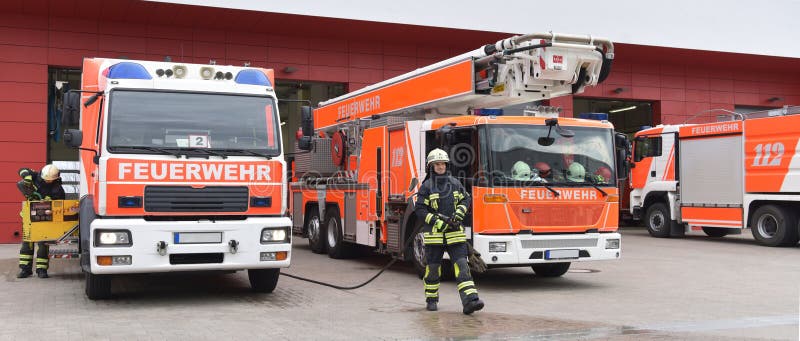 Group of Firefighters at the Emergency Vehicle in the Fire Station ...