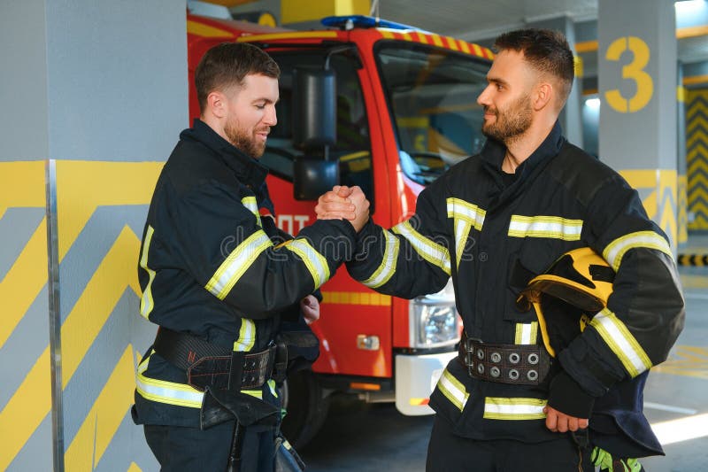 Group of Firefighters at the Emergency Vehicle in the Fire Station ...