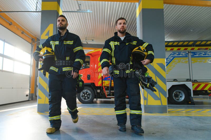 Group of Firefighters at the Emergency Vehicle in the Fire Station ...