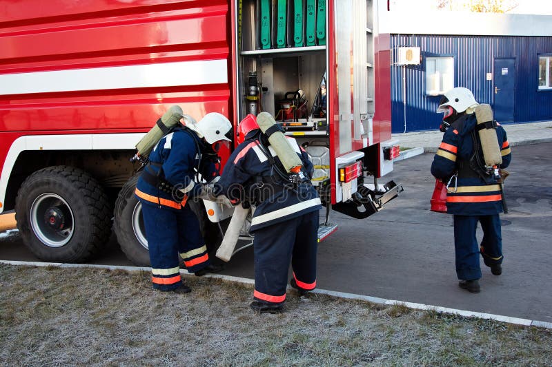 Group of Firemen Putting on Gas Masks and Preparing for Extinguish Fire ...