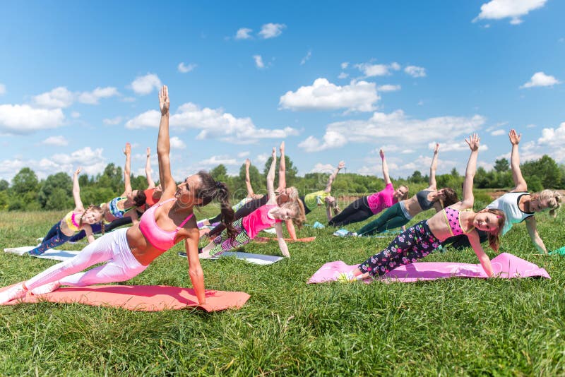 Group of Fit Girls Going Side Plank Exercise in Nature on a Sunny Day ...