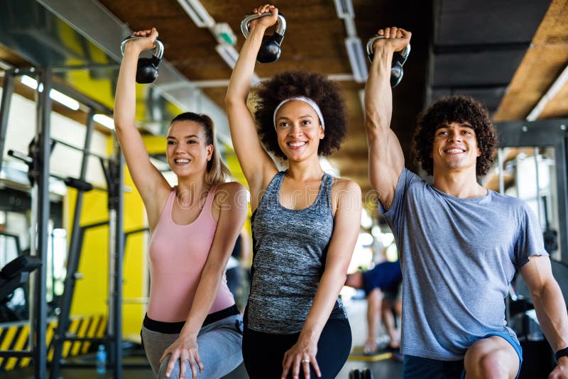 Group of Fit People Lifting Dumbbells during an Exercise Class at the ...