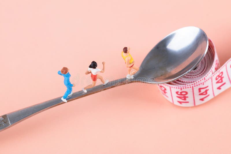 A Group of Fitness Miniature Figures Running on a Spoon Stock Image ...