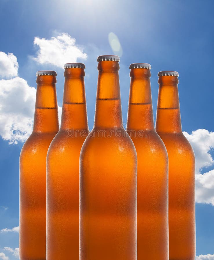 A Group of Five Beer Bottles in a Diamond Formation on Sky Background ...