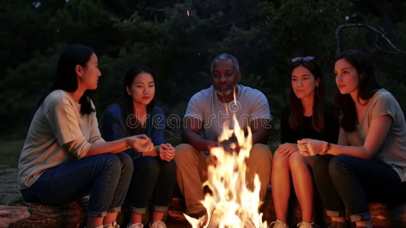 Campfire Conversations: Friends Gather Round Fire on Wood Log, Share ...