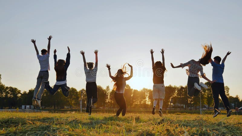 Group of Five Happy Friends Jumps at Sunset Time on Background ...