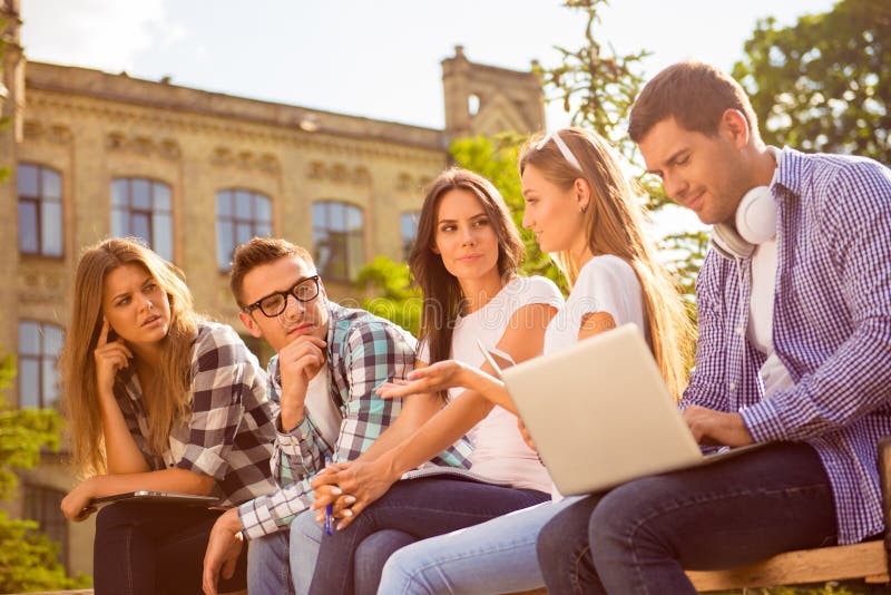 Group of Five Happy Students Sitting on Bench and Talking Stock Image ...